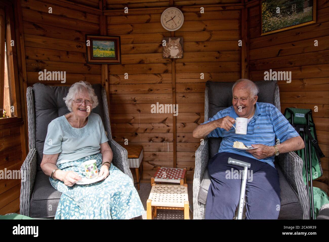 Elderly couple in their 80's enjoying the warm summer weather at their ...