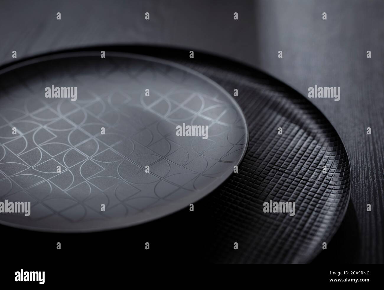 Two 2 black patterned plates hi-res stock photography and images - Alamy