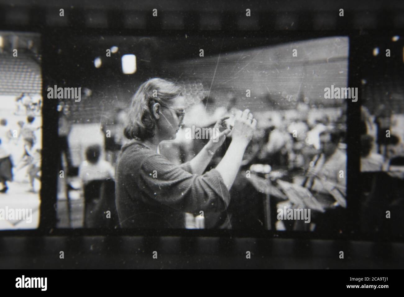 Fine 1970s vintage black and white photography of a photographer taking a picture with a camera ...