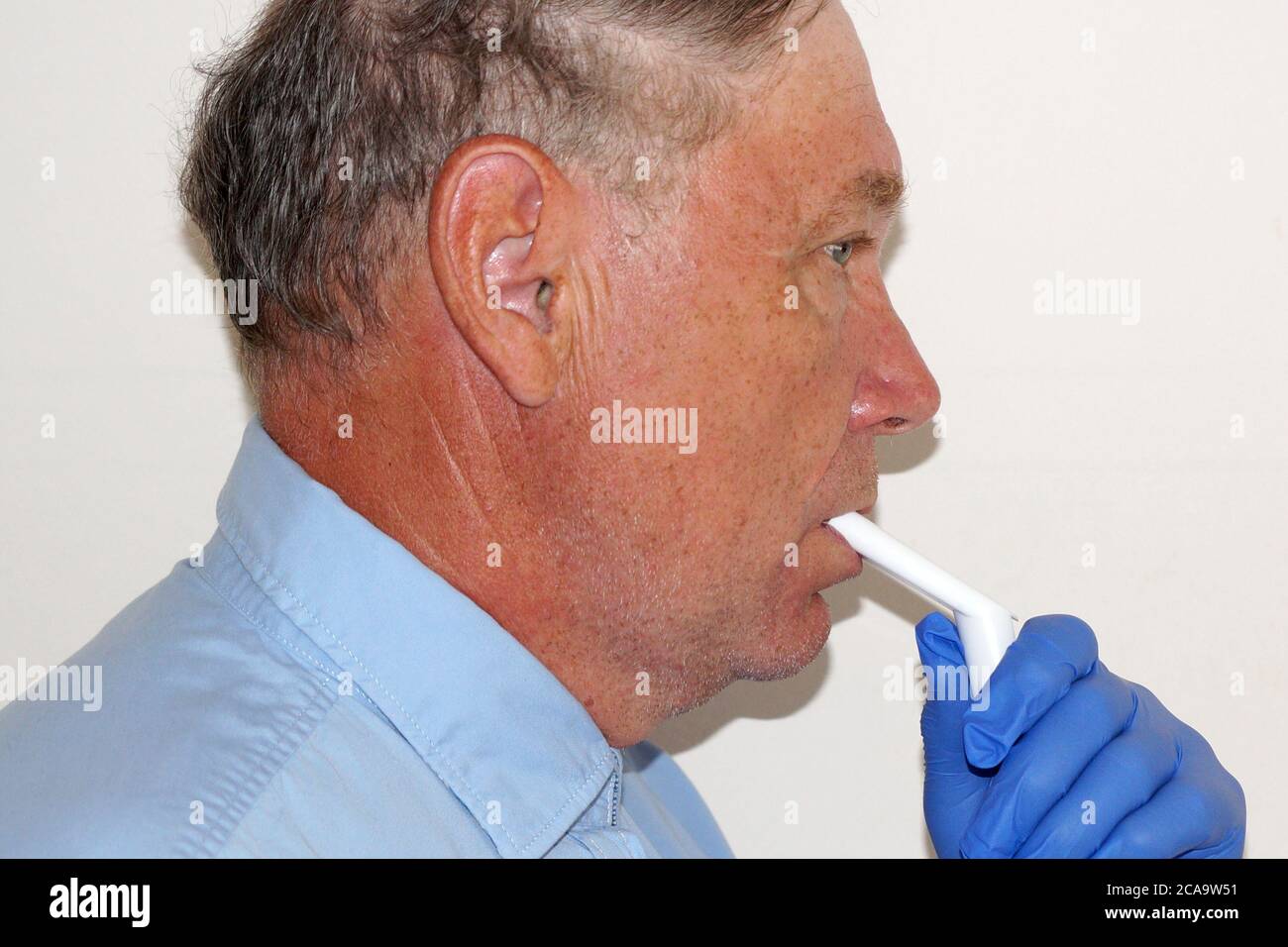 old man breathing through an inhaler, portrait close up Stock Photo - Alamy