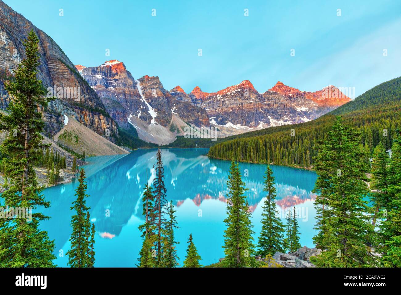 Summer sunrise lighting up the Valley of the Ten Peaks at Moraine Lake near Lake Louise in the ...