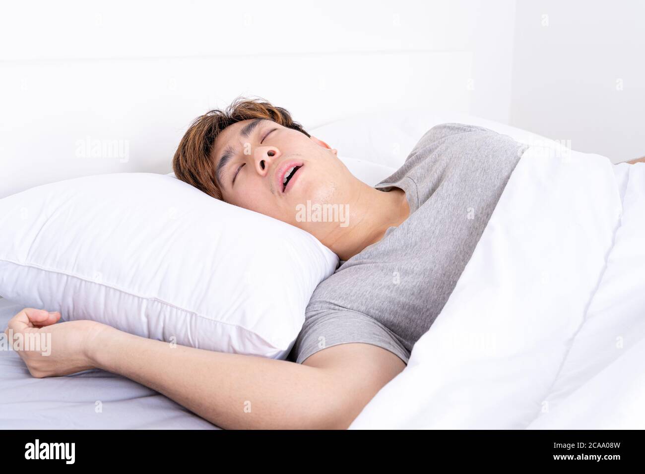 Man snoring loudly because of tired from work, sleep apnea lying in the ...