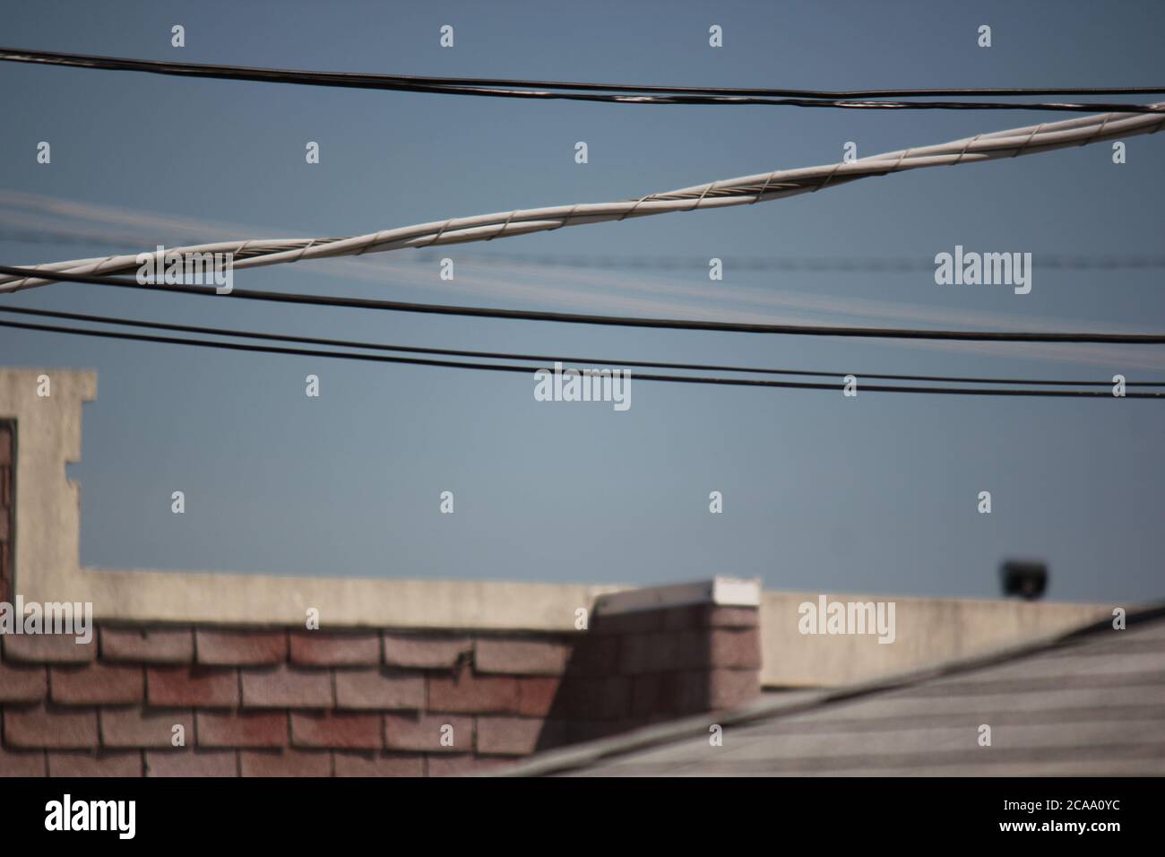 Bunch of electrical and power utility wires hanging in the backyard ...