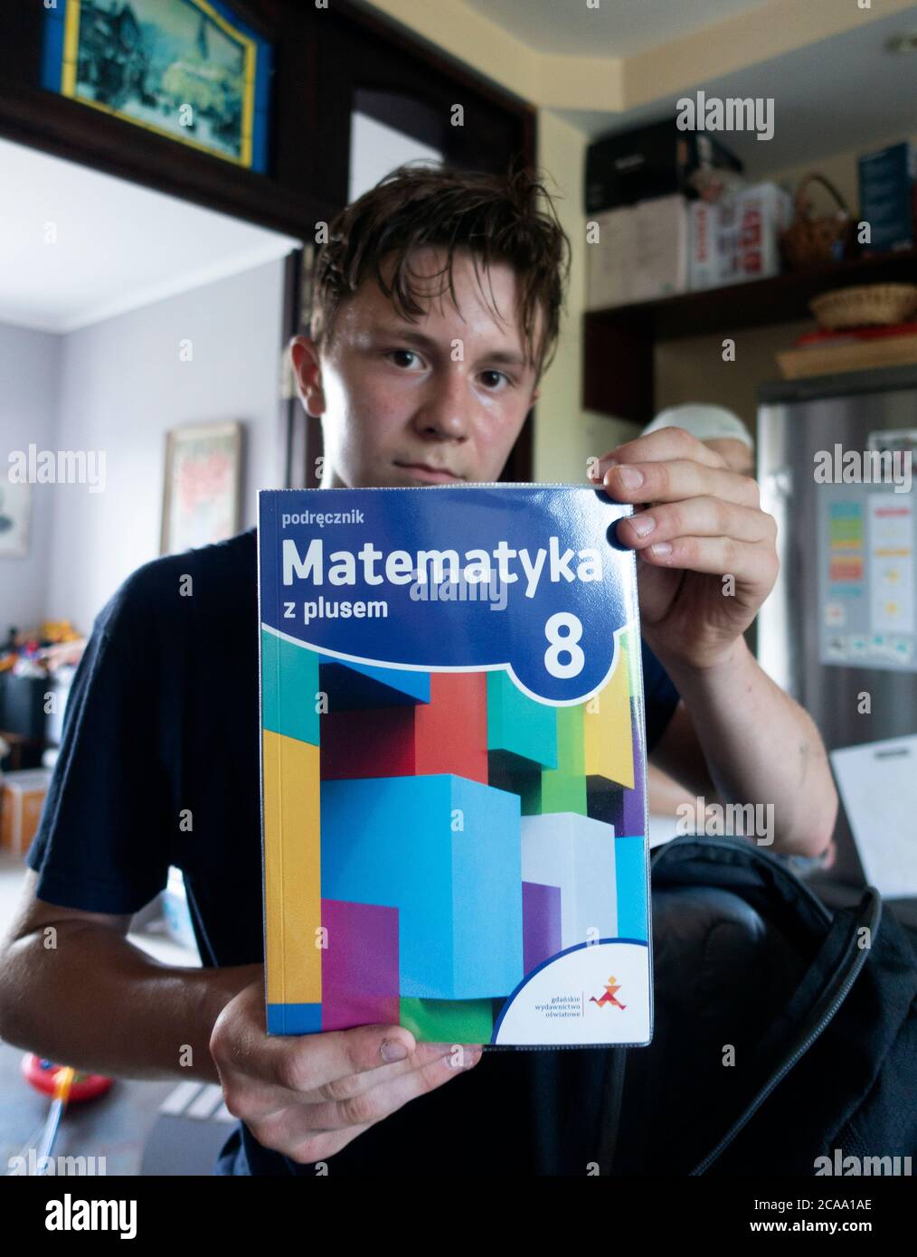 Serious Polish teen holding a book about Math. Zawady Gmina Rzeczyca ...