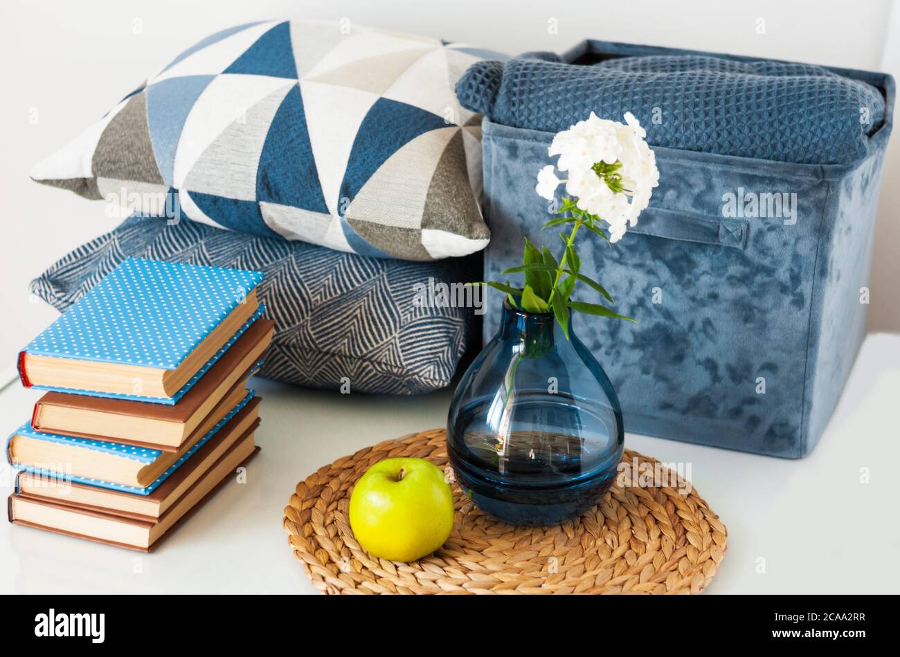 Cozy home interior decor: stack of books, green apple, decorative ...
