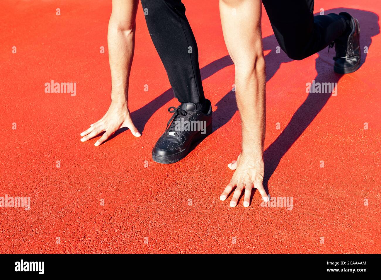 hands and feet of an unrecognizable male runner ready to run, concept ...