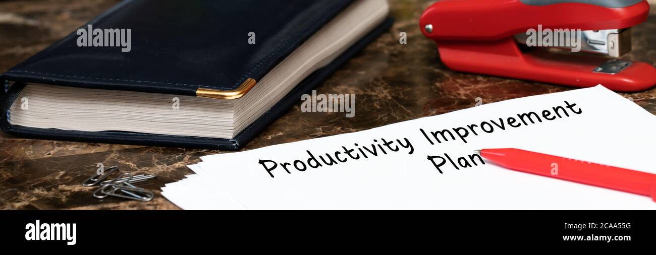 productivity improvement plan on the table next to the red pen. Drawing ...
