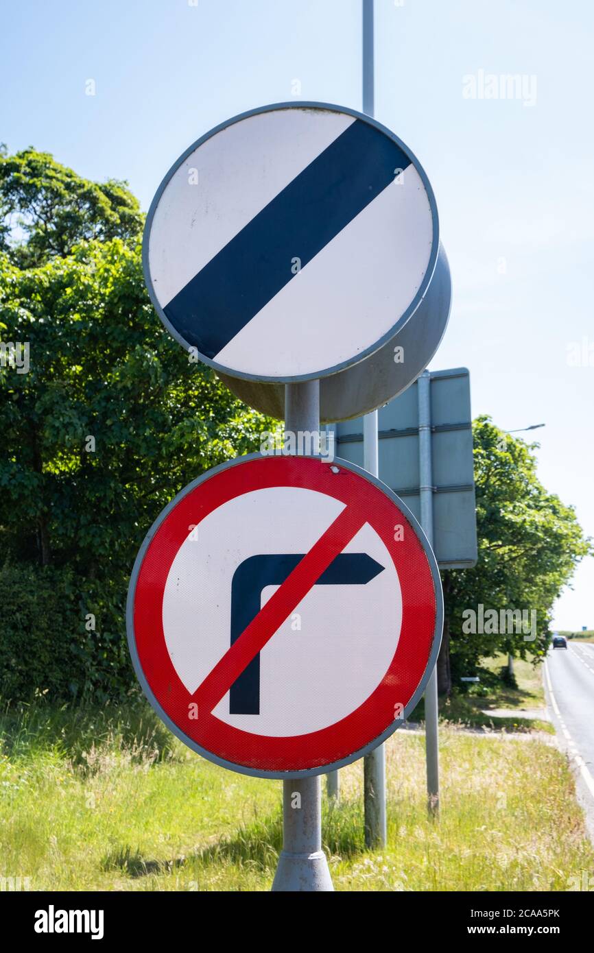 National speed limit and no right turn signs on side of road in ...