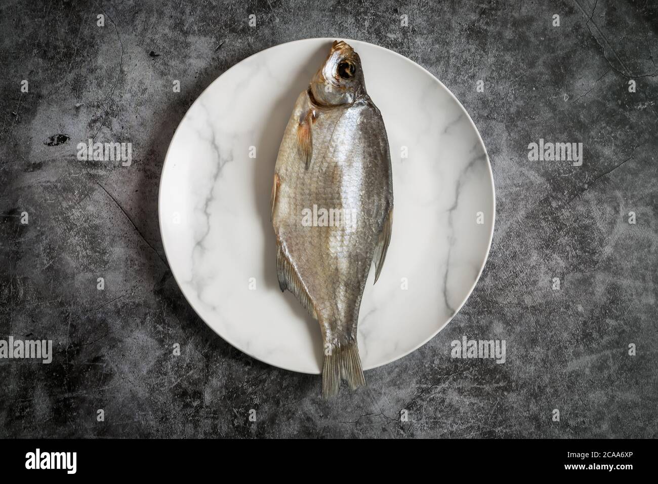 Salted and dried fish on a plate Stock Photo - Alamy