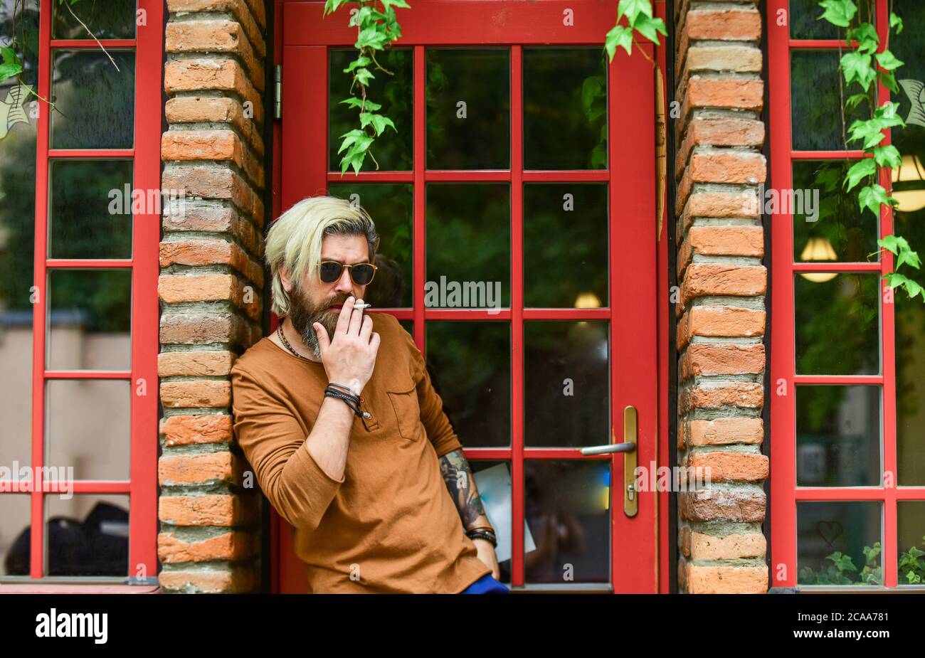 Cool guy relaxing. Went on smoke break. Hipster smoking irish pub ...