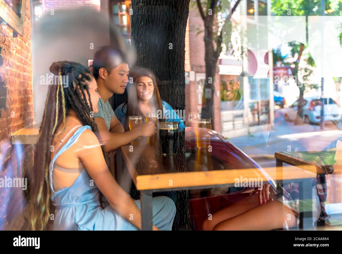 A group of friends sitting together in a restaurant Stock Photo - Alamy