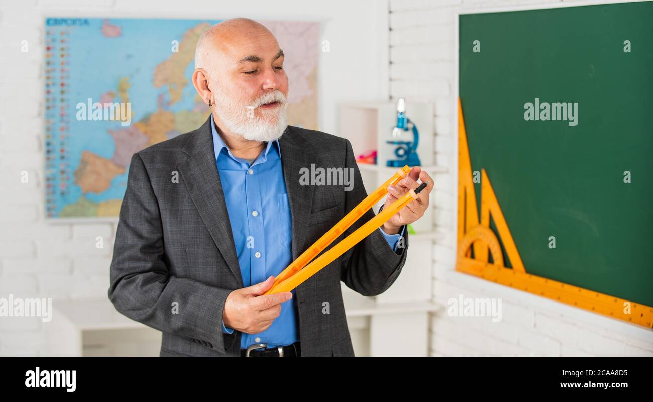 Senior intelligent man teacher at chalkboard. Education goals. School ...