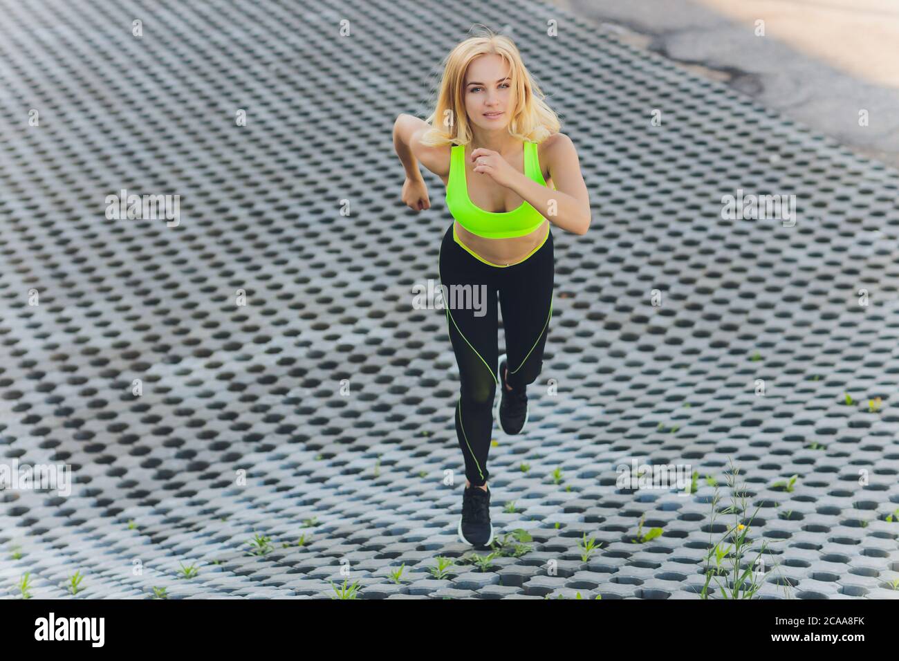 Top view of woman running on city asphalt. Female runner training ...