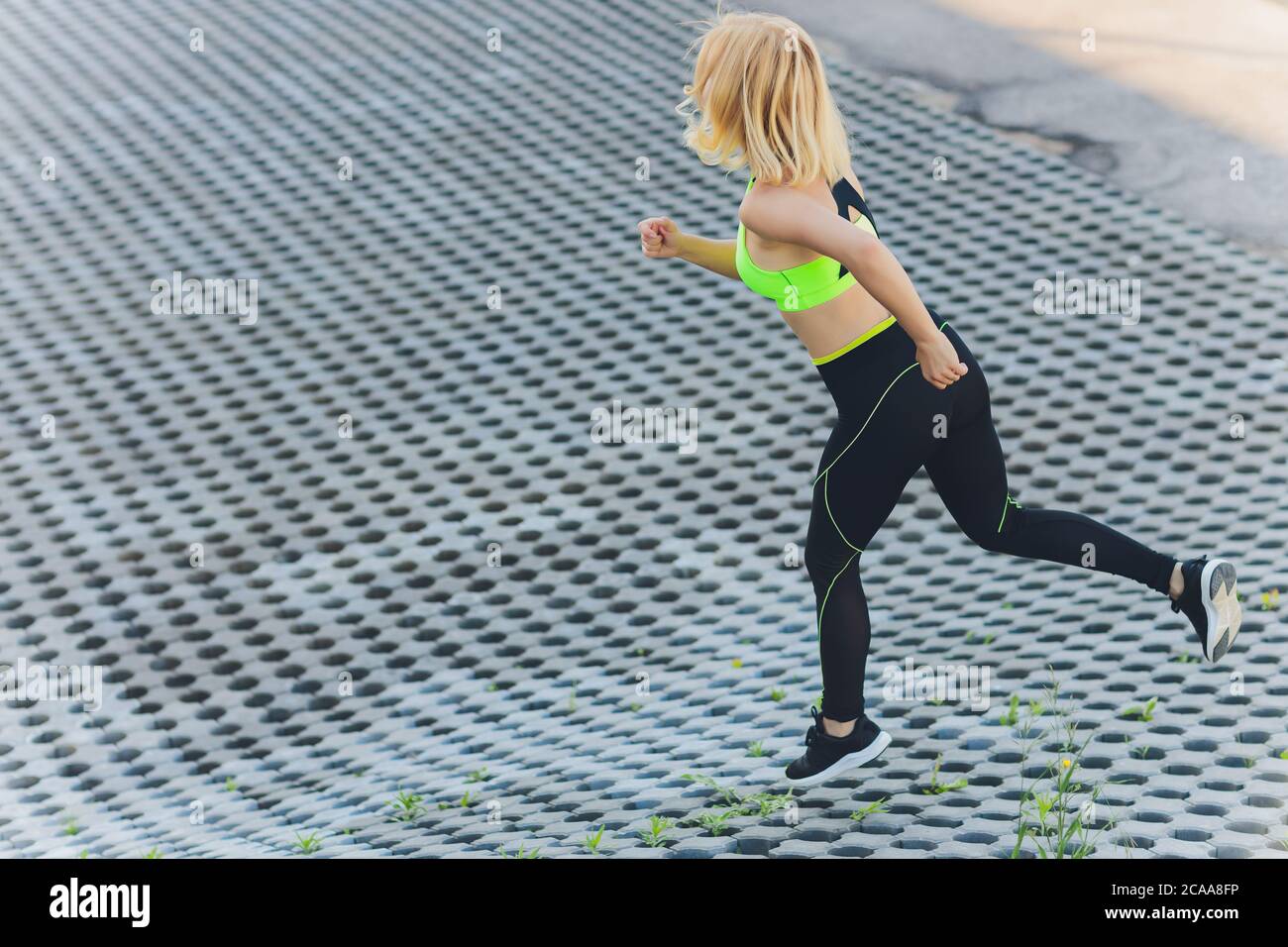 Top view of woman running on city asphalt. Female runner training ...