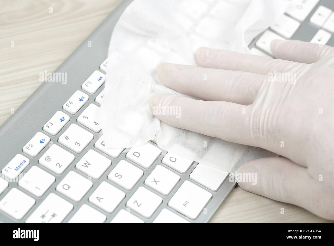 hand in rubber glove cleaning or disinfecting the keyboard Stock Photo ...