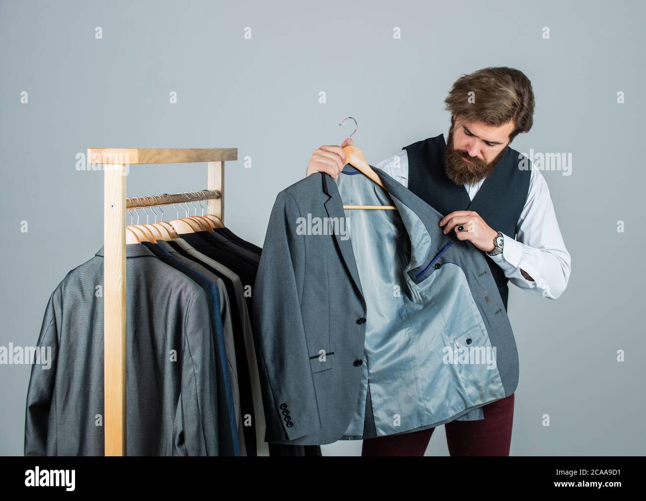 Man with suit. tailor in his workshop. Handsome bearded fashion man in ...