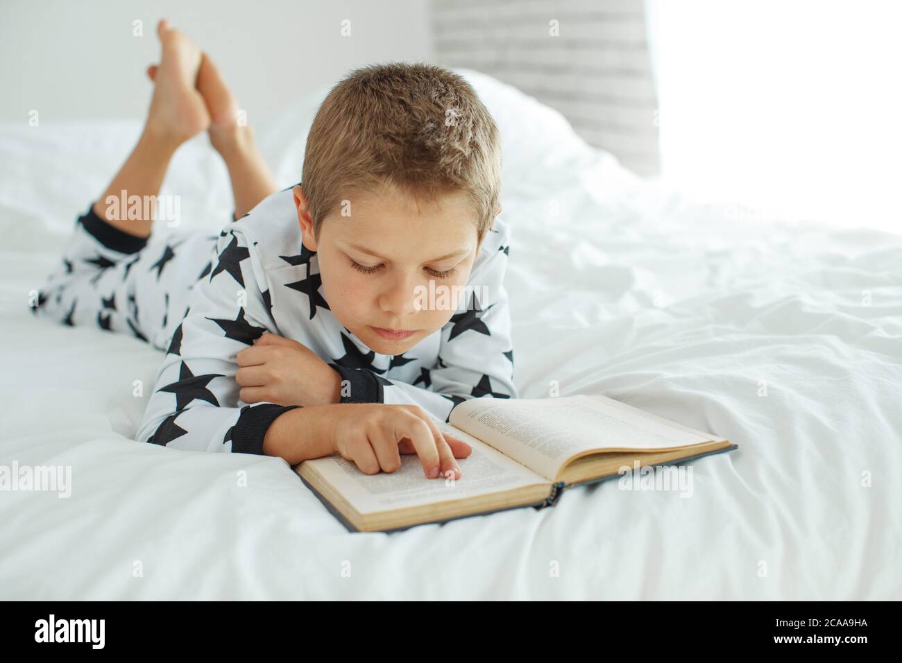 Children are reading a book Stock Photo - Alamy