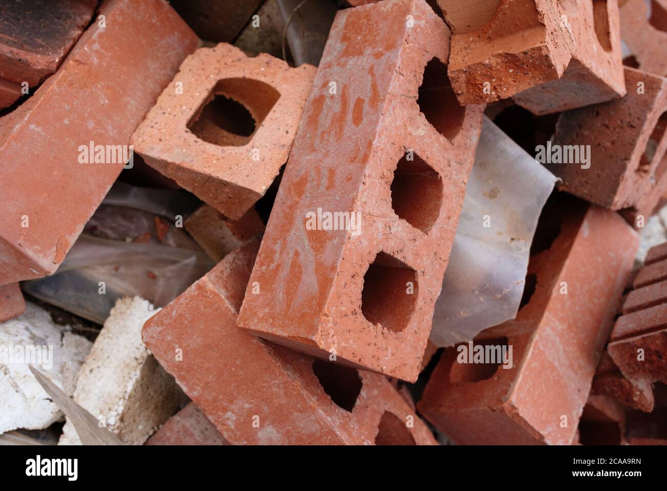 A pile of red bricks on the construction site Stock Photo - Alamy