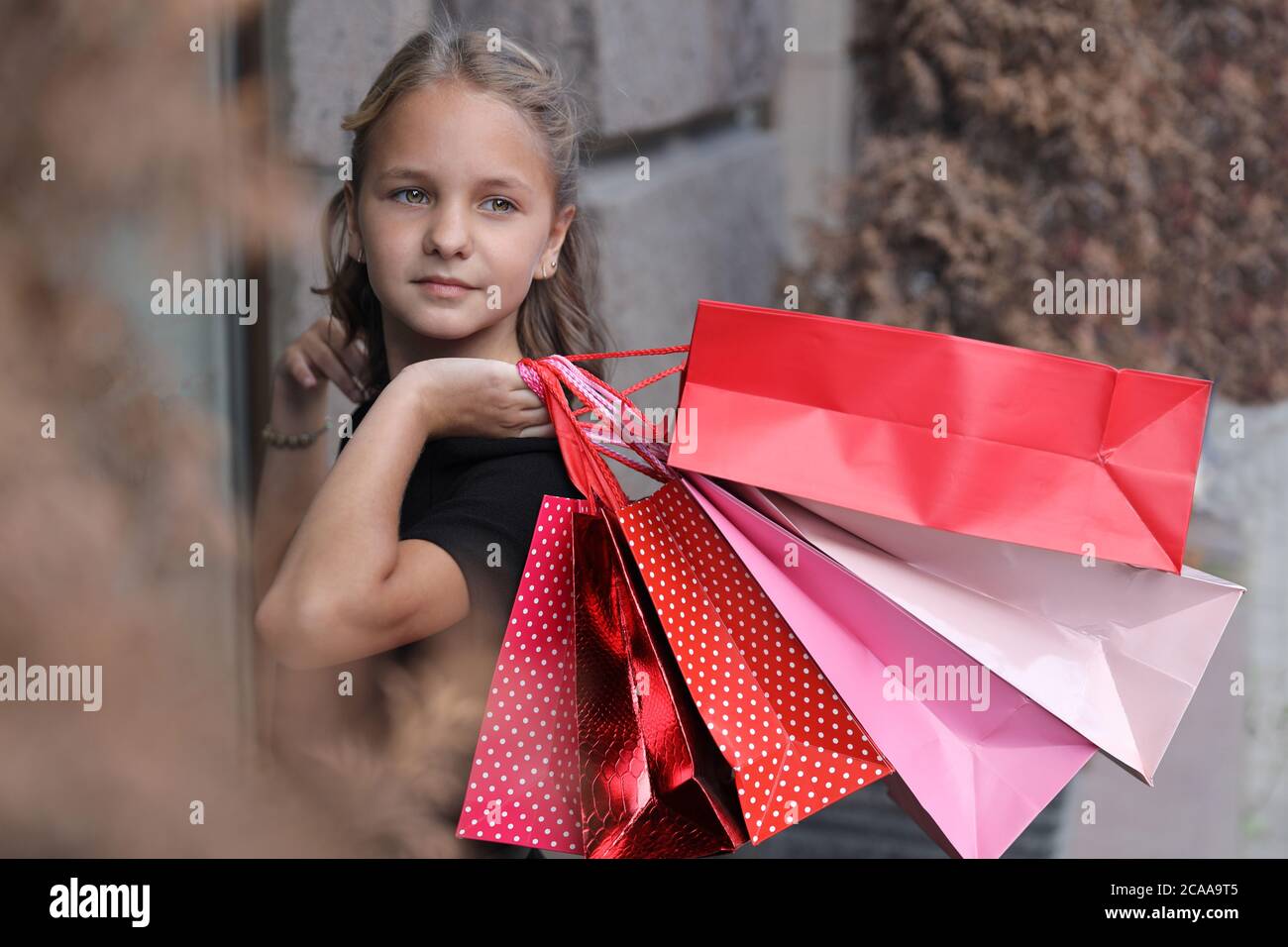 beautiful girl holding colored bags in her hands Stock Photo - Alamy