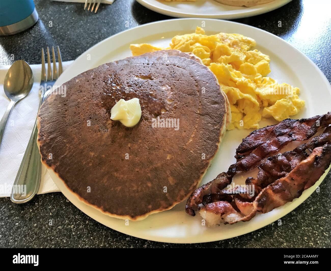 Breakfast meal with scrambled eggs and pancakes Stock Photo - Alamy