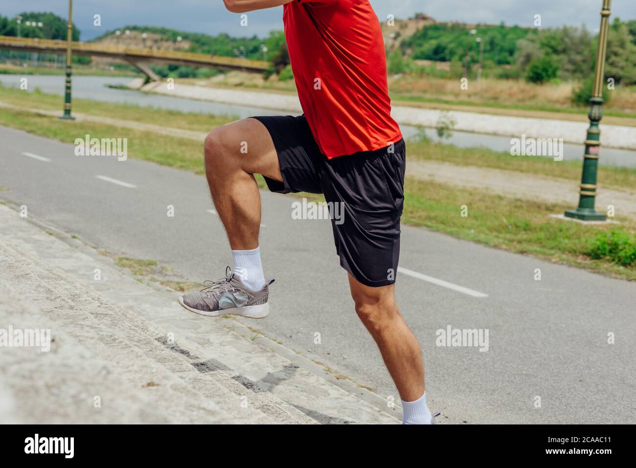 Fit male athlete performing stairs workout, running up climbing stairs ...