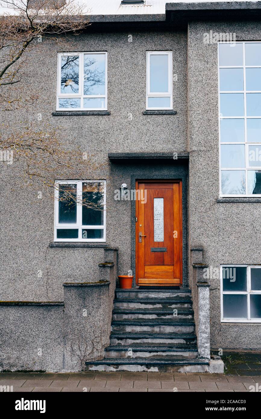The entrance is from a wooden door into a modern two-story building ...