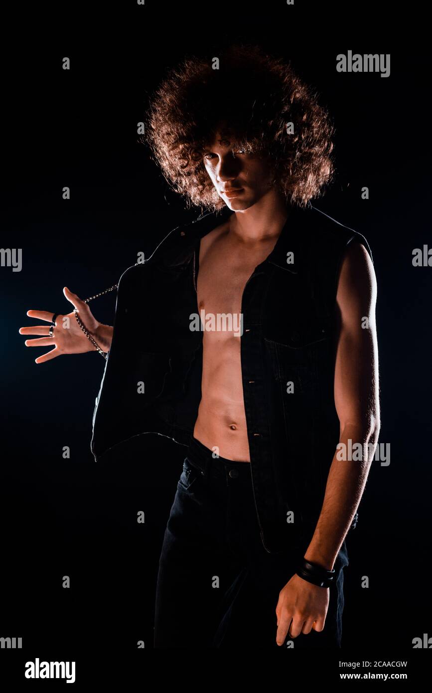 Portrait of an attractive young punk guy posing with unbuttoned jeans ...