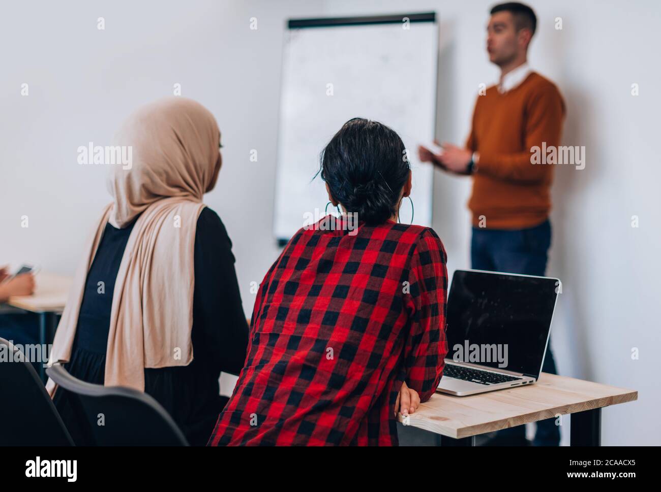 Modern business team listening to the company speaker during a lecture ...