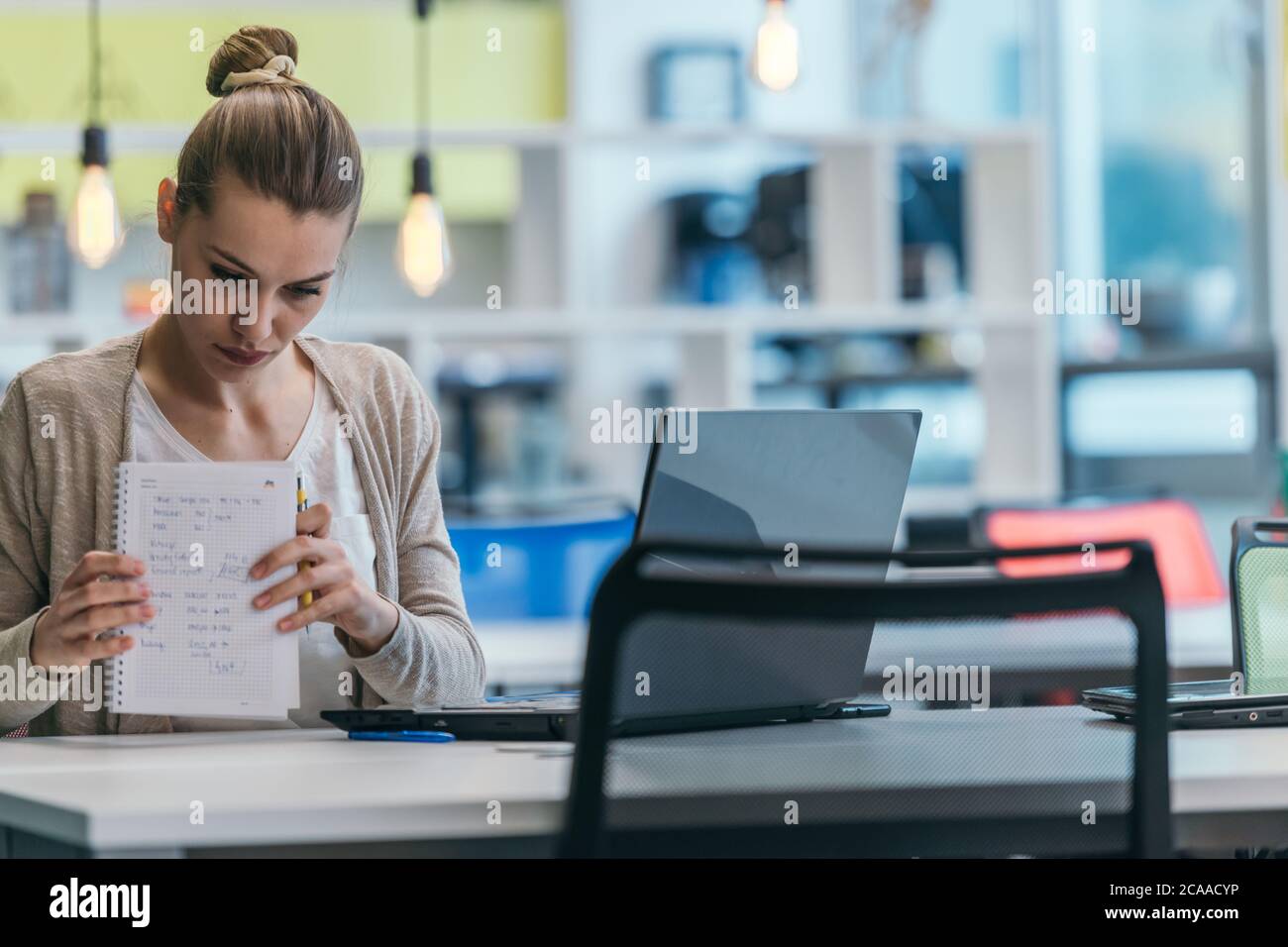 Blonde manager working behind her desk in a modern office Stock Photo ...
