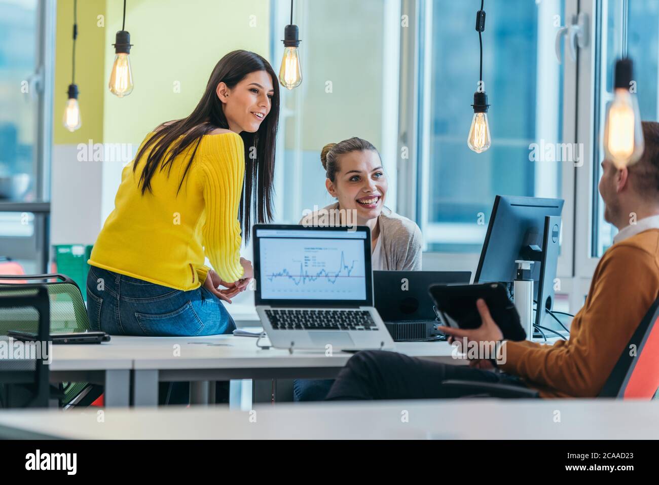 Group of professional coworkers ( team ) working on a desk in a modern ...