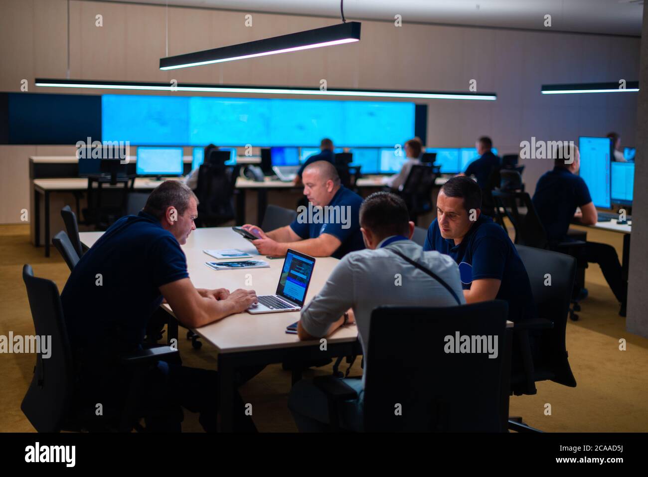 Group (security officers) tech guys meeting in a main security data ...