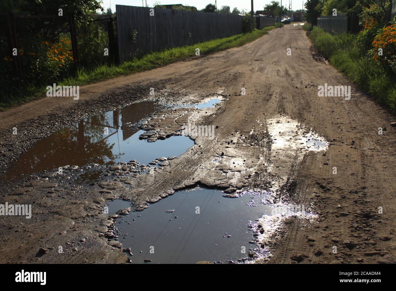 broken destroyed washed out road after a bad weather storm with holes ...
