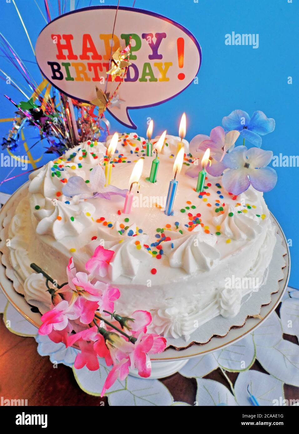Birthday cake with lit candles Stock Photo - Alamy