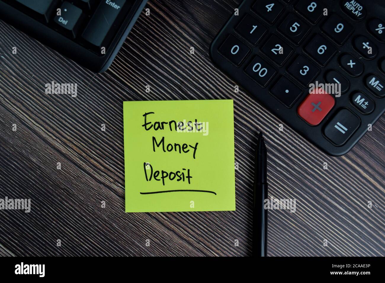 Earnest Money Deposit write on sticky notes isolated on office desk ...