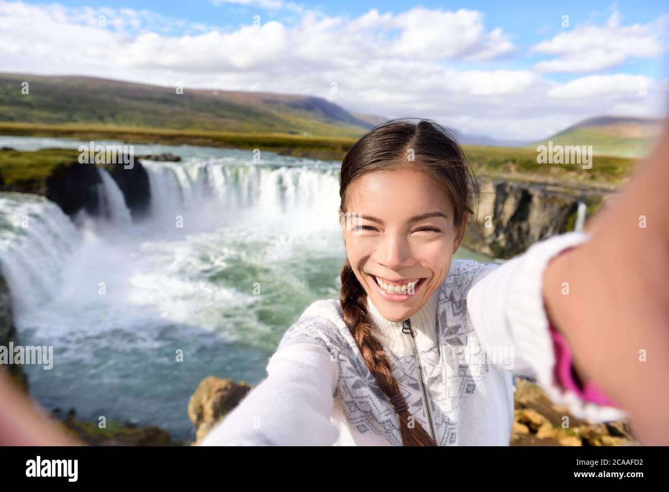 Tourist taking video selfie on travel by Godafoss waterfall on Iceland ...