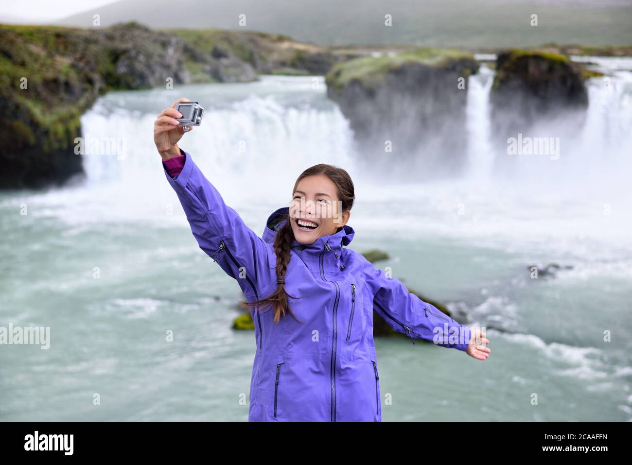 Iceland tourist taking selfie photo with smart phone by Godafoss ...