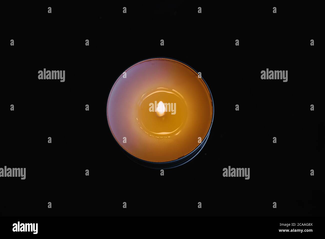 Overhead photo of aromatherapy candle lighted on black background Stock ...