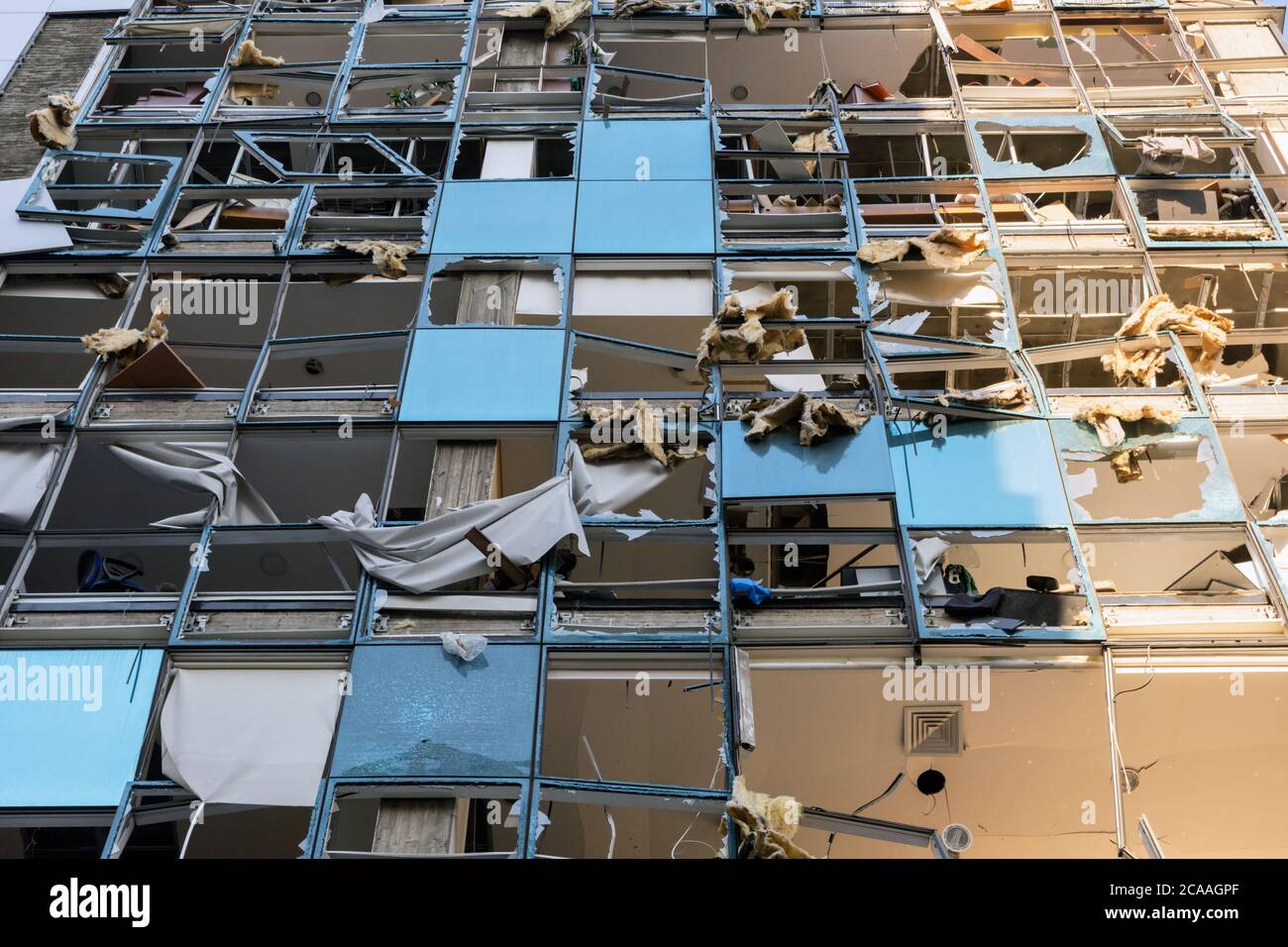 Commercial center facade with shattered windows after a massive ...
