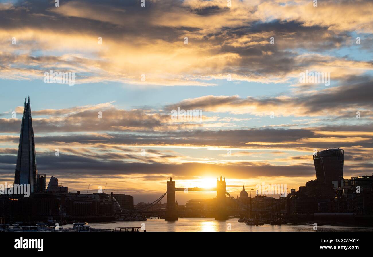 The sun sets behind the London skyline, including (left to right) the ...