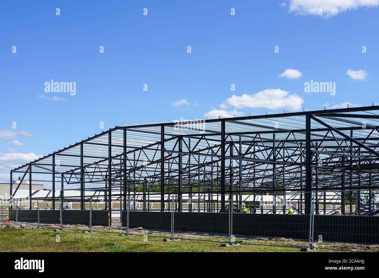 construction of a new modern industrial building, metal truss frame ...