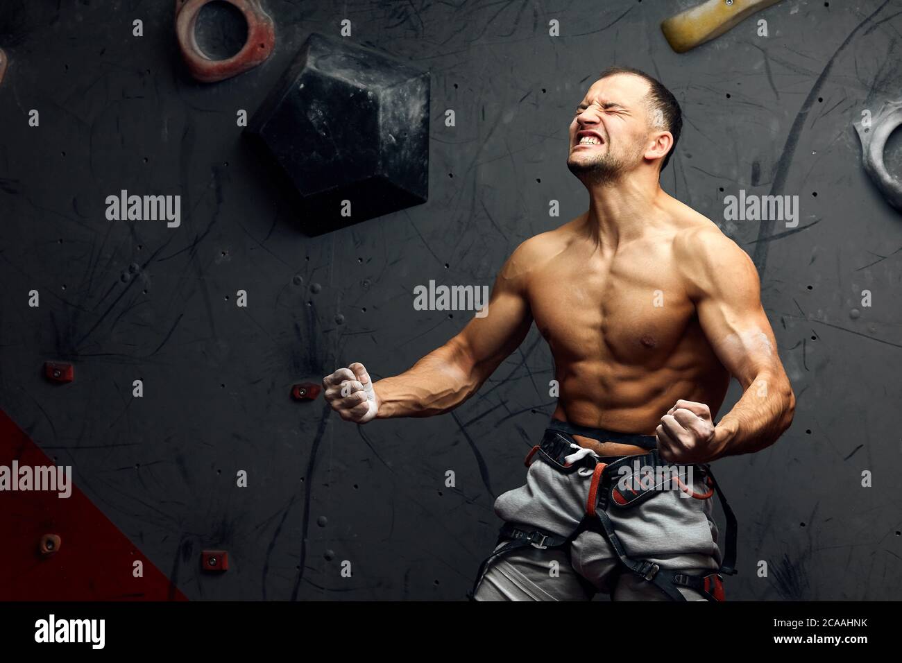 Success concept -shirtless man with perfect fit body flexing his ...