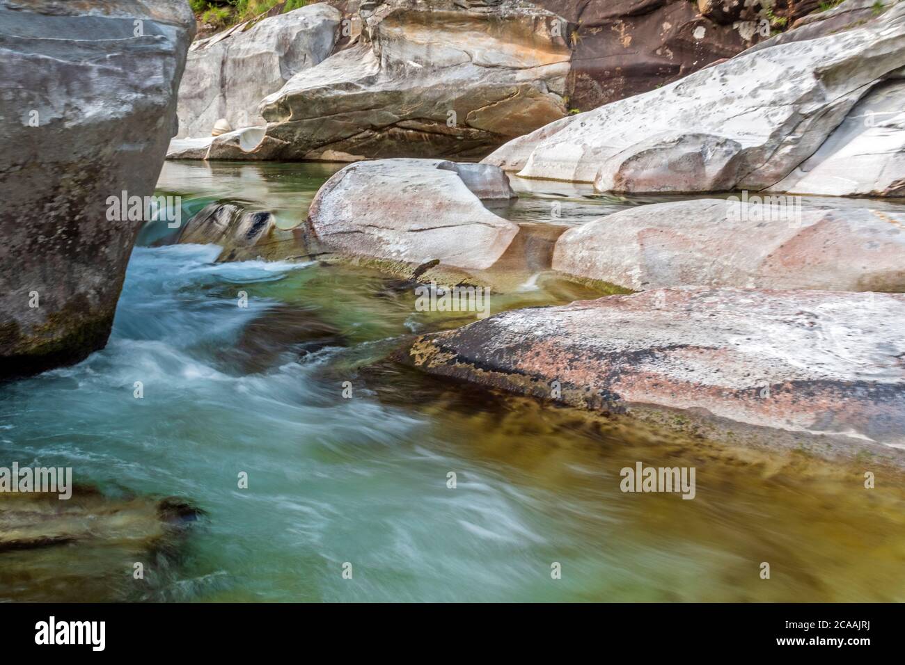Pure water of a mountain river that cheerfully flows between white and ...