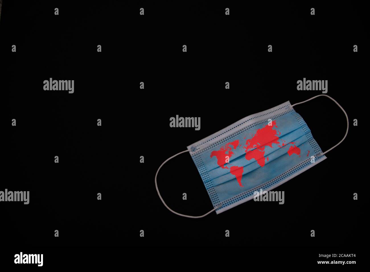 Concept. Disposable medical surgical mask on black background, with a ...