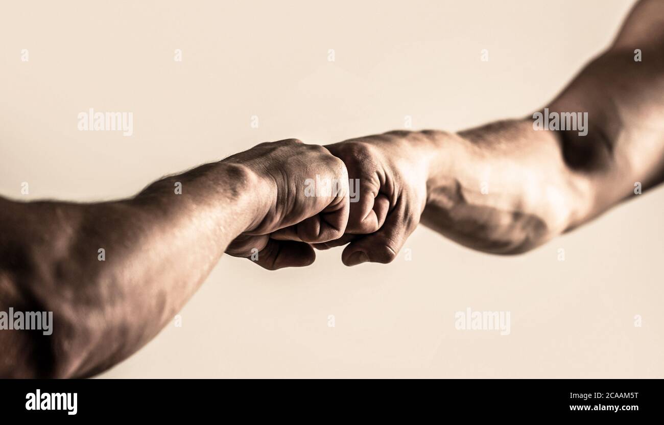 People bumping their fists together, arms. Friendly handshake, friends ...