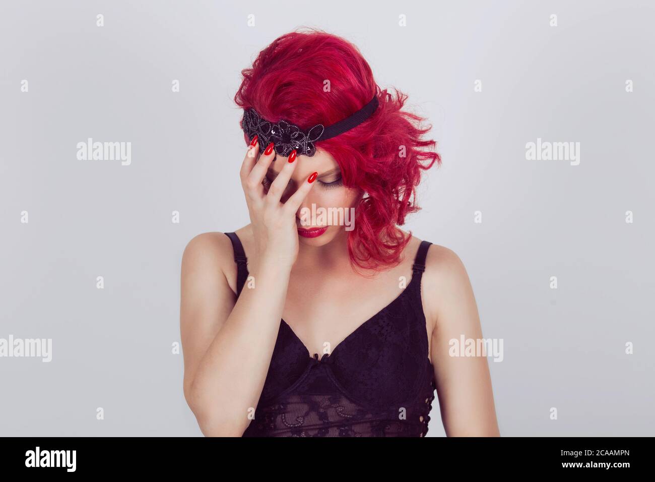 One sad upset woman covering her face with hand in depression gesture ...