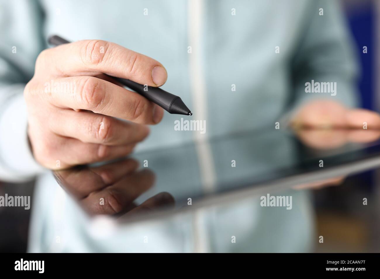 Male hand holding stylus going to make notes Stock Photo - Alamy