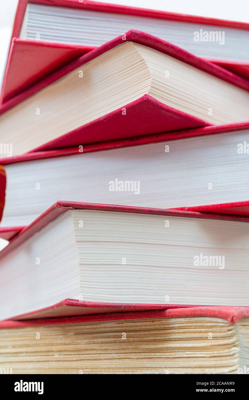 Vertical shot of a stack of red books on white background Stock Photo ...