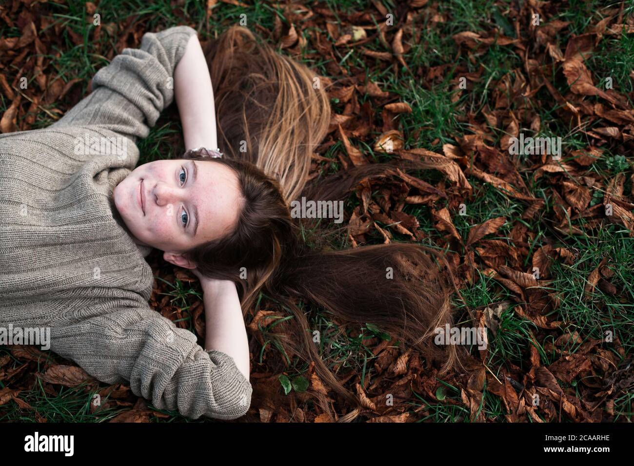 Girl laying on the ground hi-res stock photography and images - Alamy