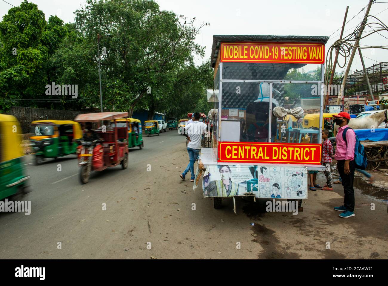 A covid19 mobile testing van is parked at a slum area during a free ...