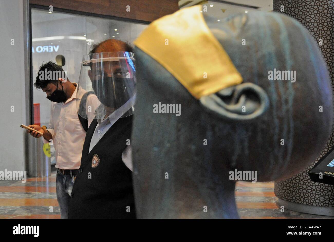 A sculpture wearing a face mask at a mall during the reopening.After ...